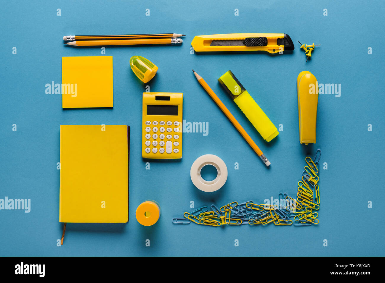 composition of yellow school supplies on blue Stock Photo - Alamy