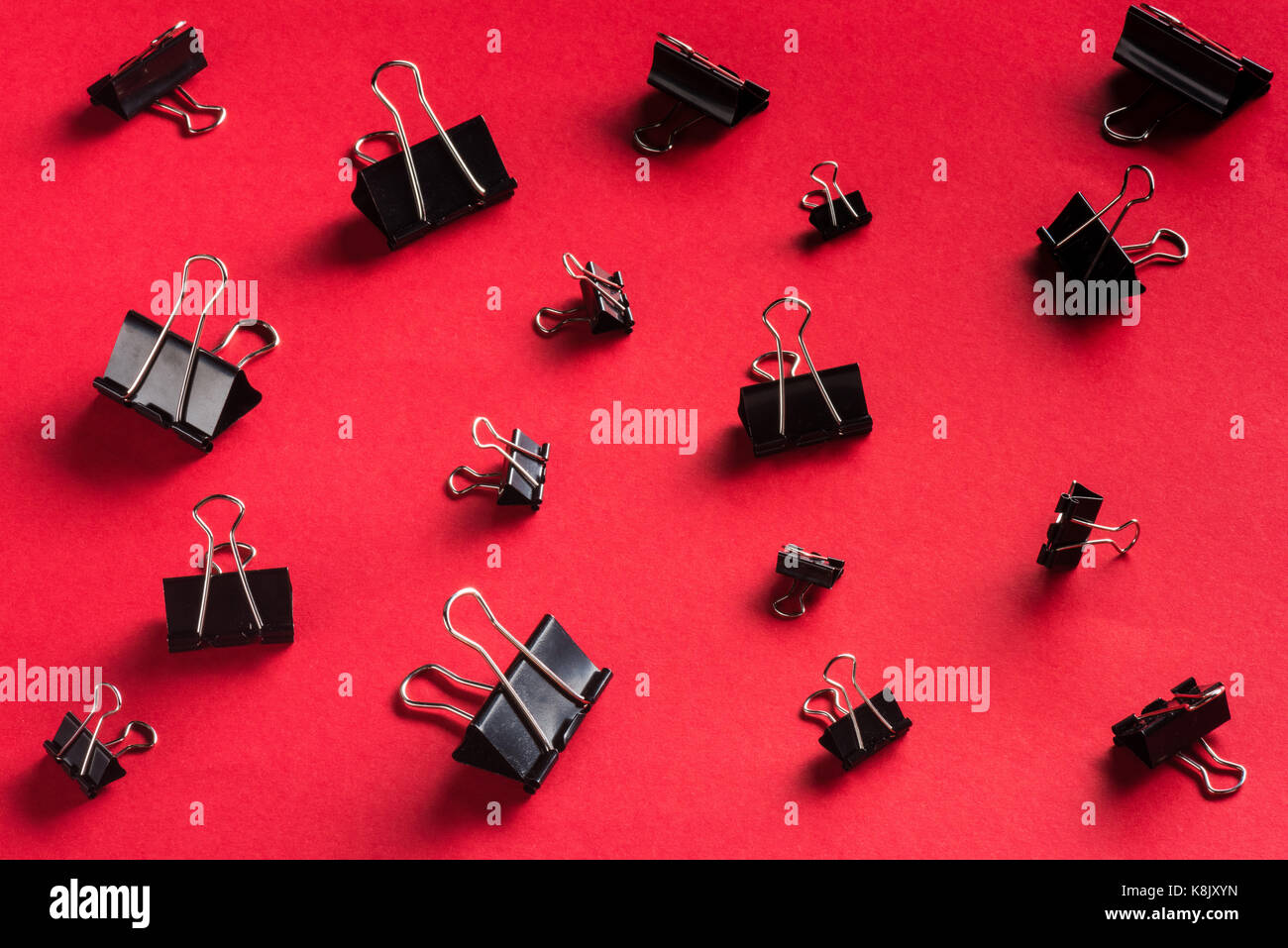 composition of various stationery clips on red Stock Photo - Alamy