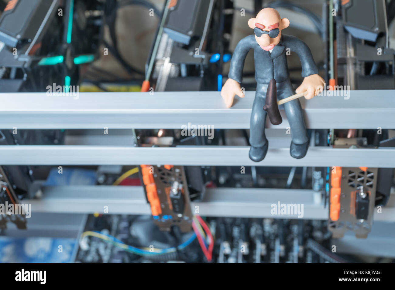 Bald plasticine man with a pickaxe mines cryptocurrency sitting on ...