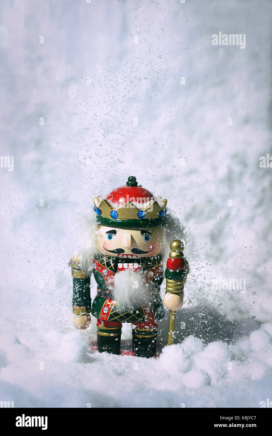 Nutcracker figure in snow scene with falling snow Stock Photo - Alamy