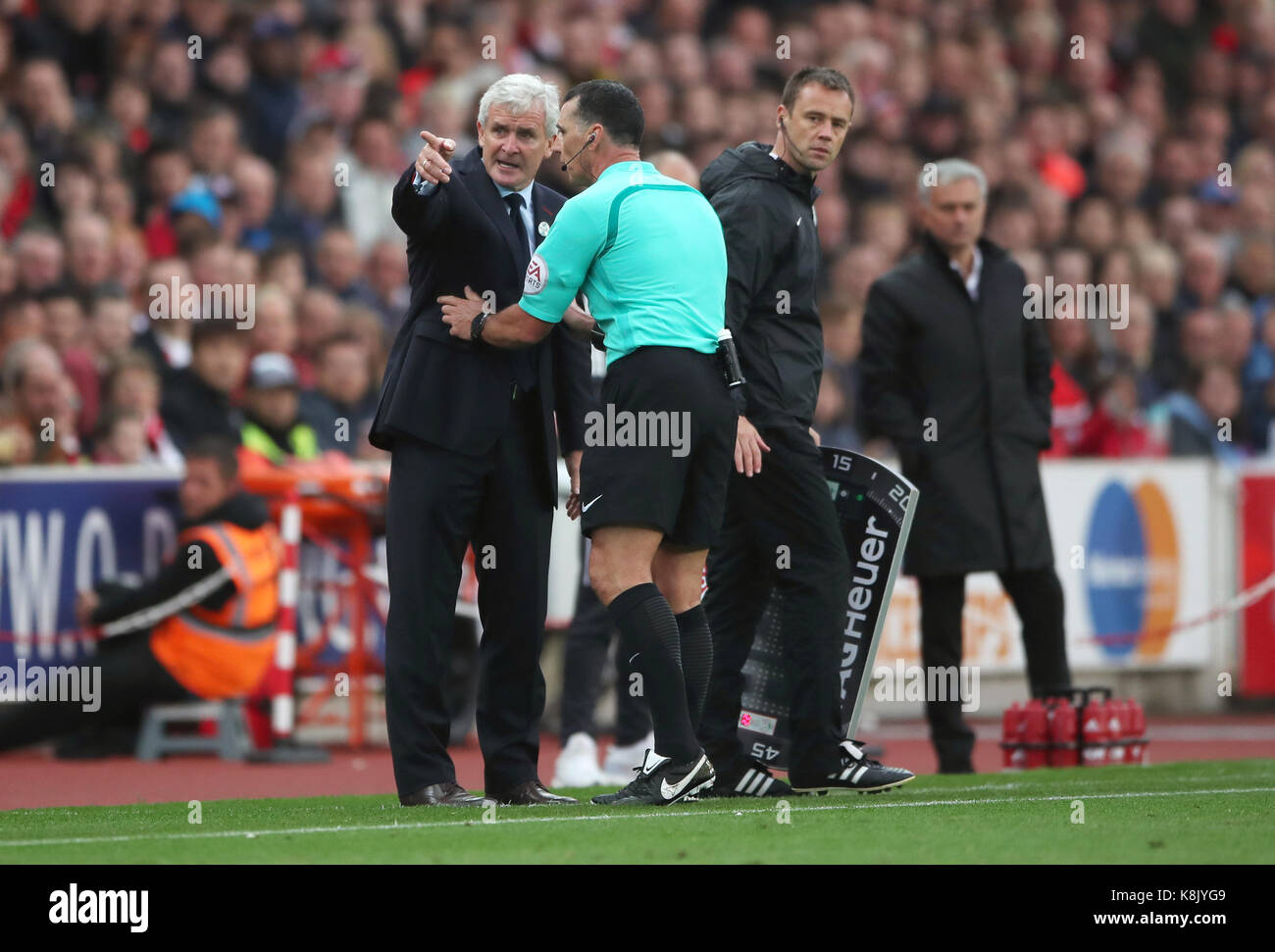 Stoke City manager Mark Hughes speaks to referee Neil Swarbrick during ...