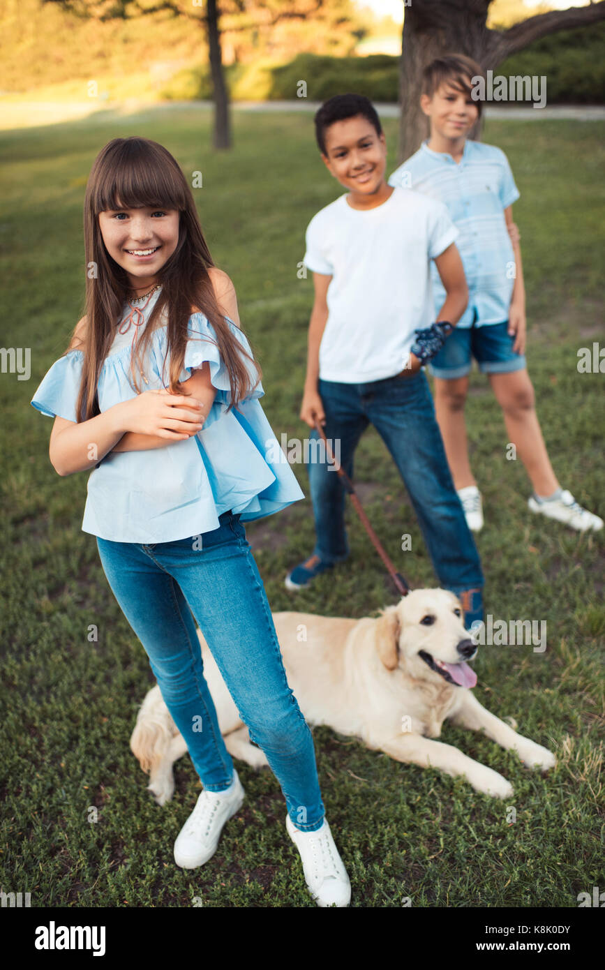 multiethnic teens with dog Stock Photo - Alamy
