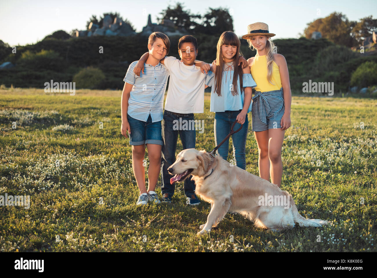 teenagers with dog in park Stock Photo - Alamy