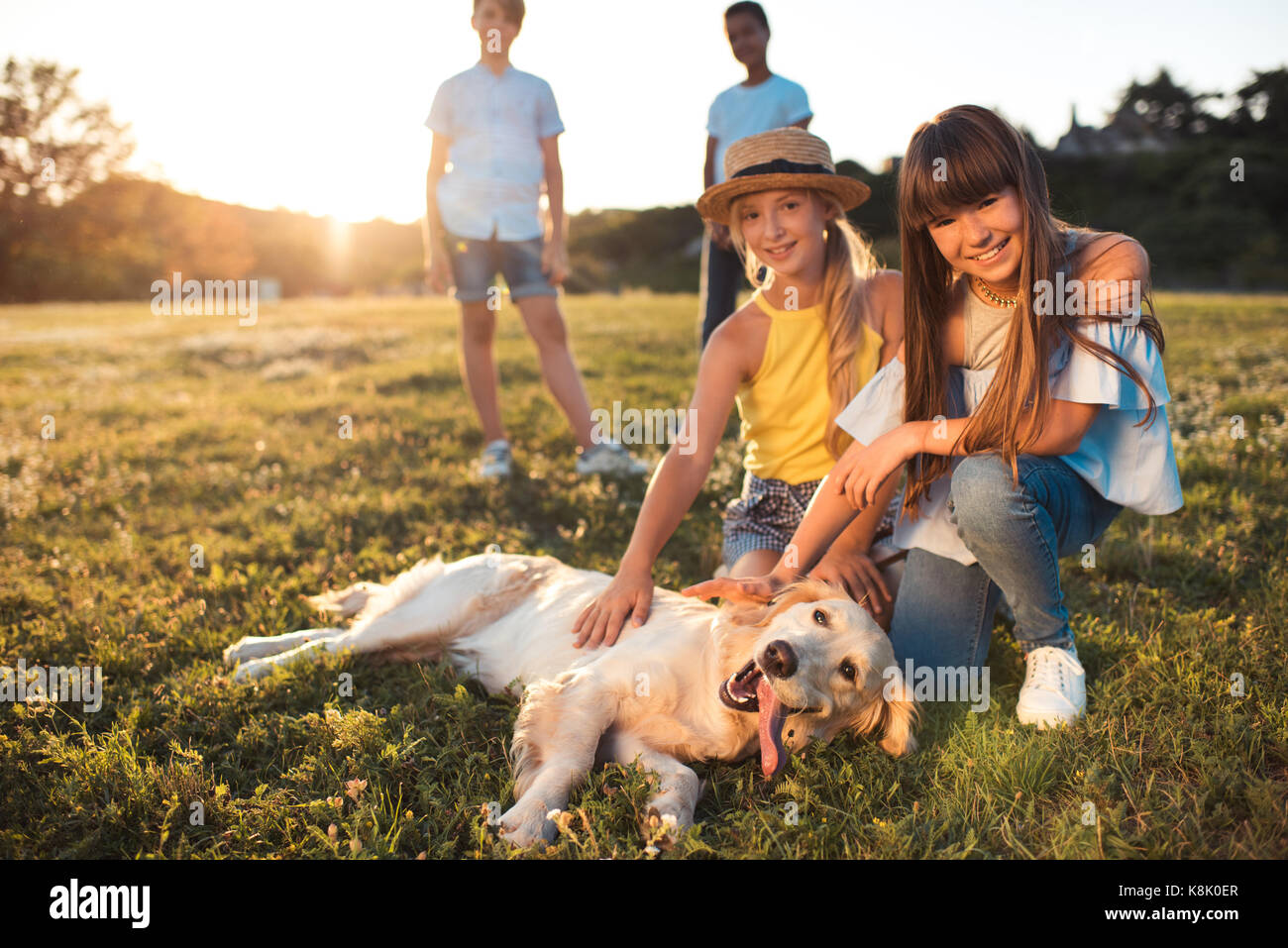 teenagers with dog in park Stock Photo - Alamy