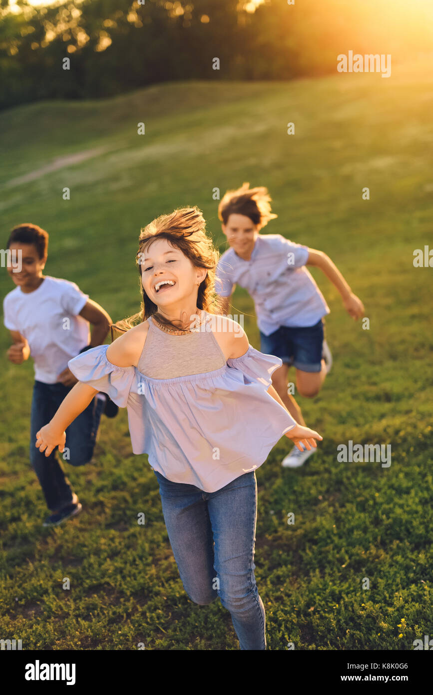 multiethnic teens running in park Stock Photo - Alamy