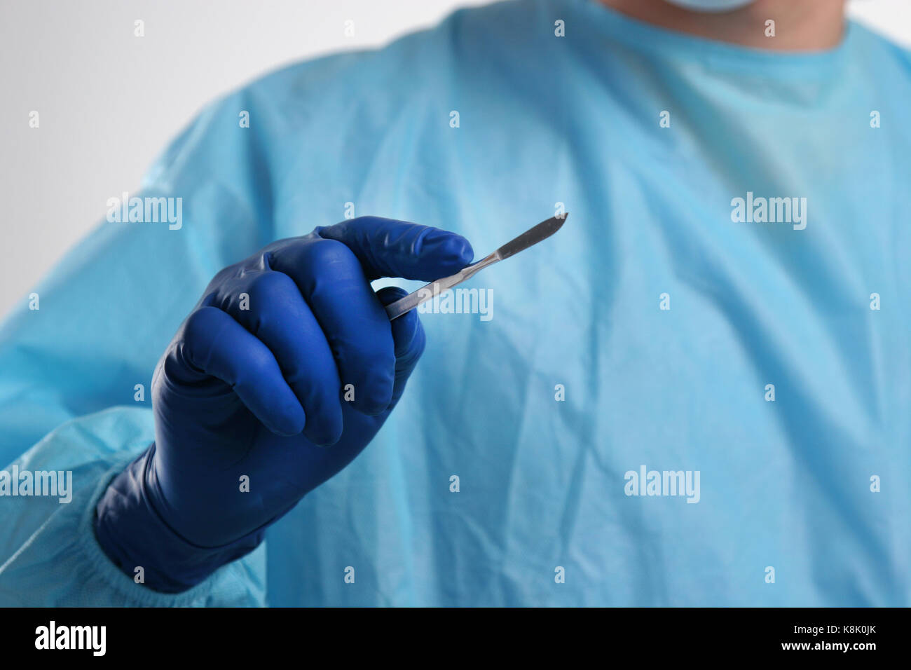 Man surgeon holds a scalpel Stock Photo - Alamy