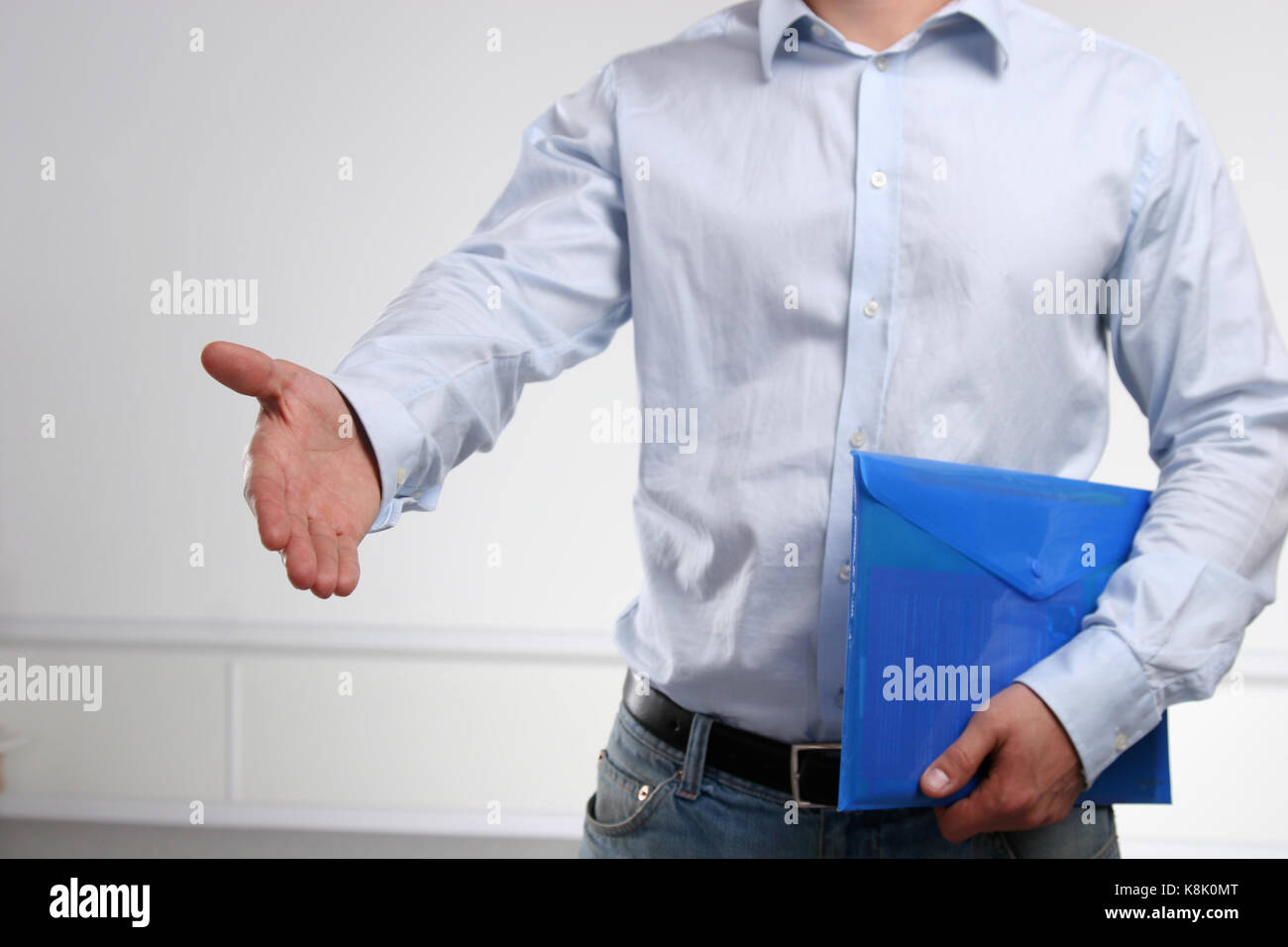 Businessman offering his hand for handshake Stock Photo - Alamy
