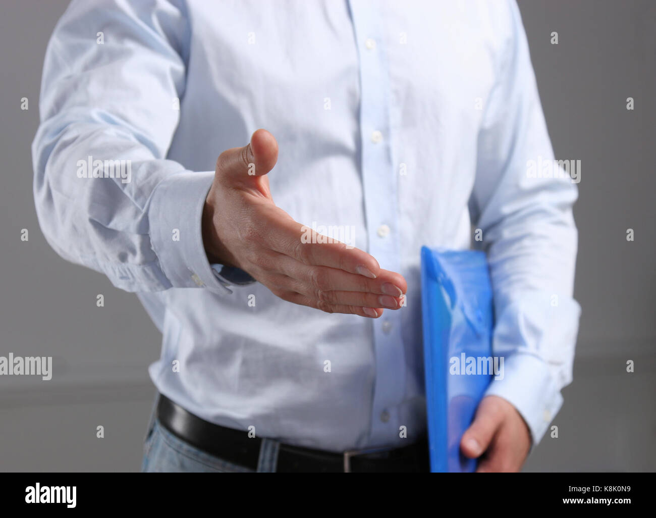 Businessman offering his hand for handshake Stock Photo - Alamy