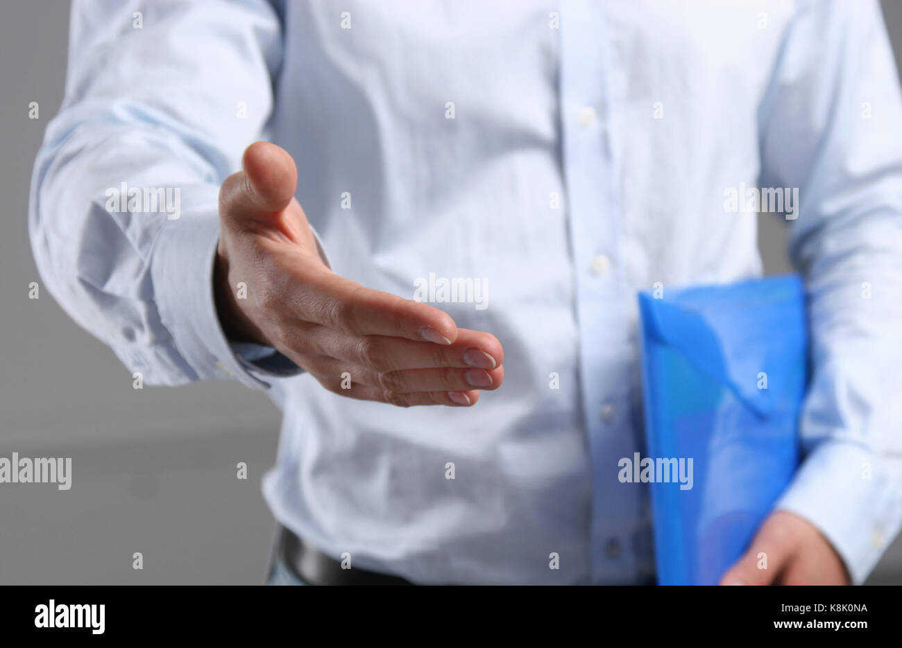 Businessman offering his hand for handshake Stock Photo - Alamy