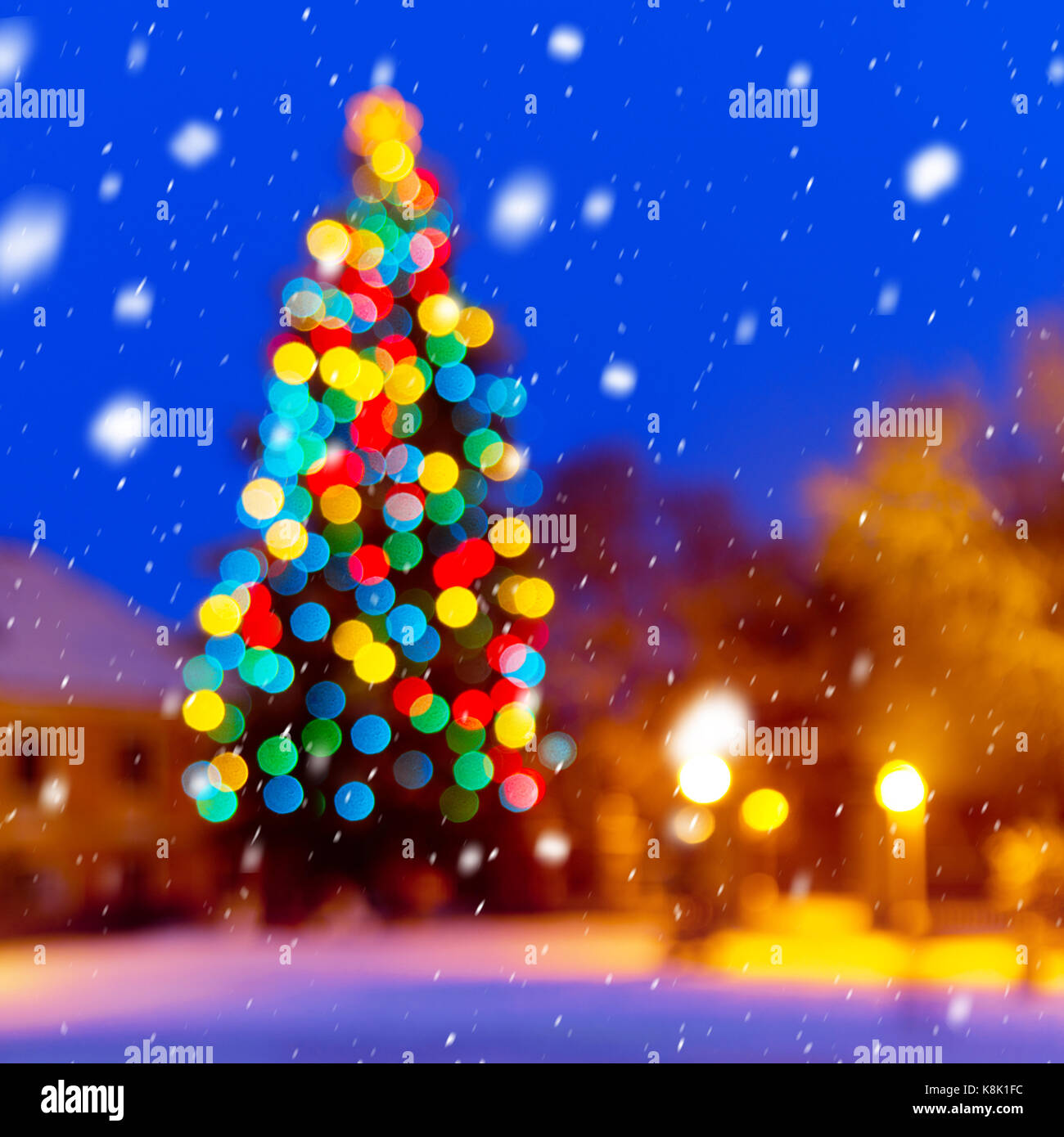 Christmas background with unfocused Christmas tree and snow by night ...