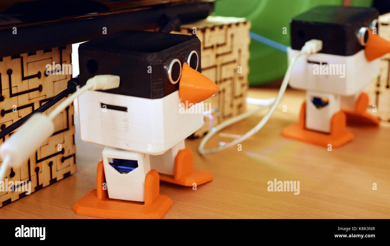 Toy automatic robots are dancing on the table Stock Photo - Alamy