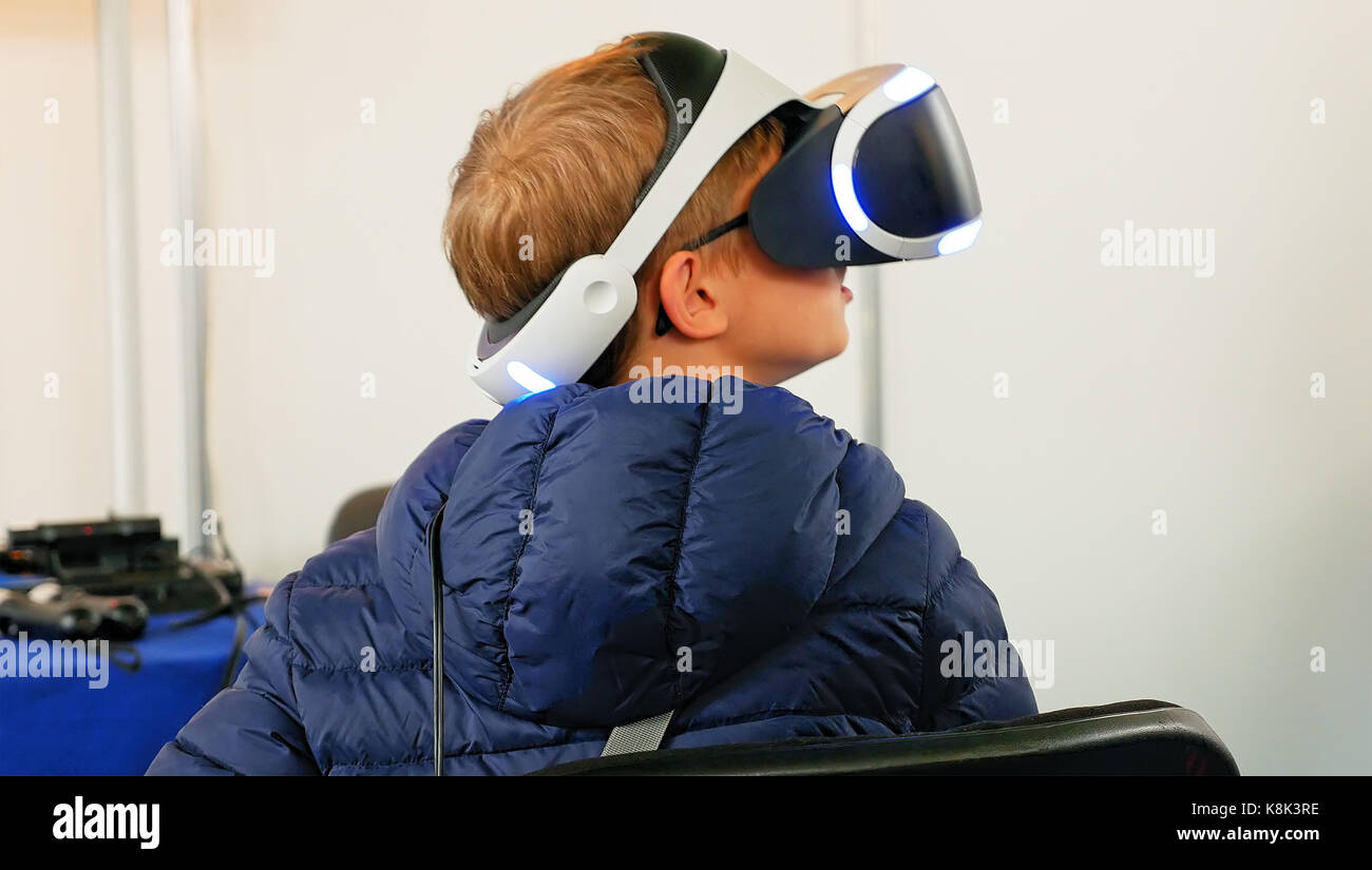 Child in VR headset playing digital virtual game Stock Photo - Alamy