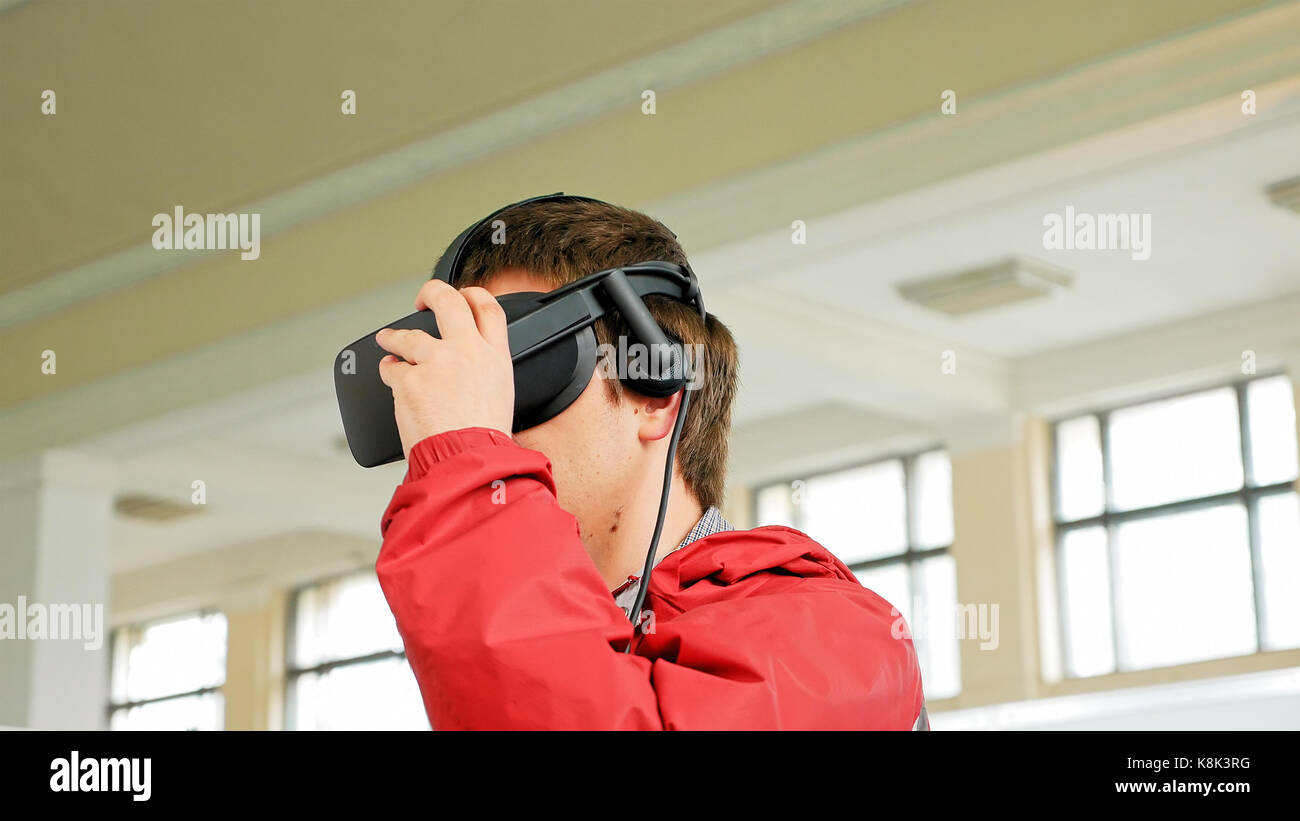 Young man in VR headset playing virtual game Stock Photo - Alamy