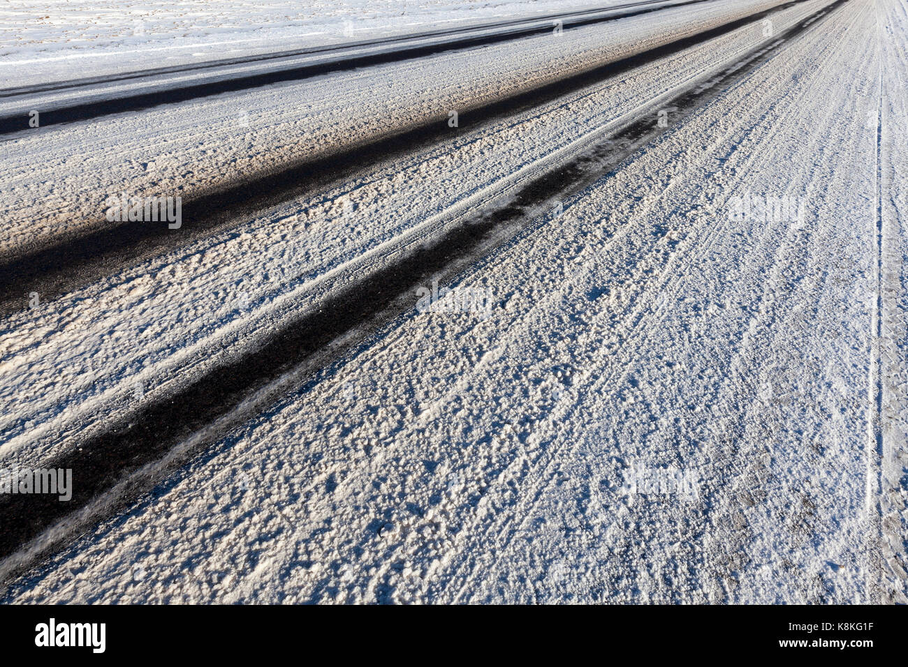 road covered with snow in the winter season. On the surface of the ...