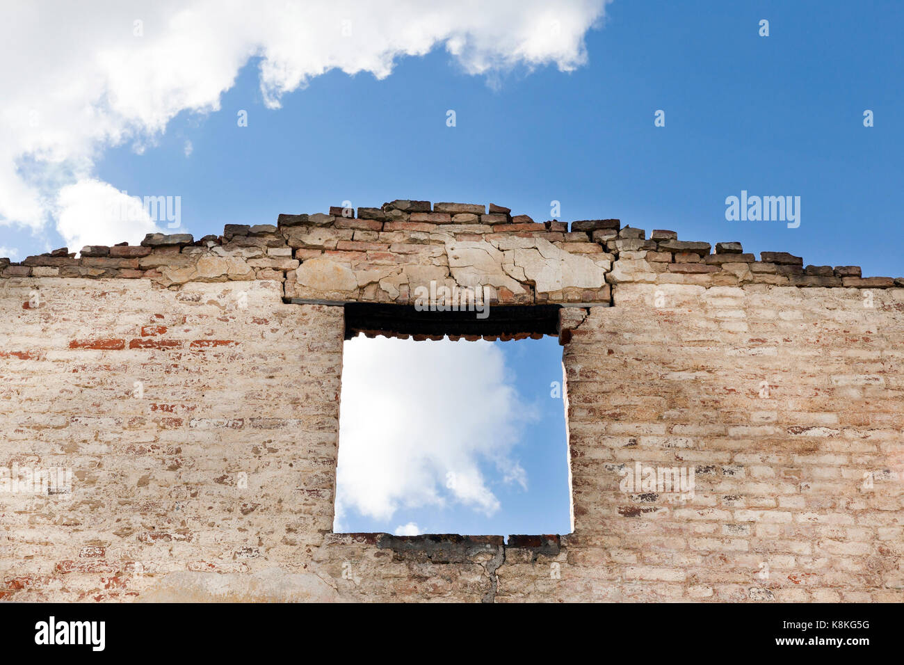 Part of the wall of the building without windows and roof after an ...