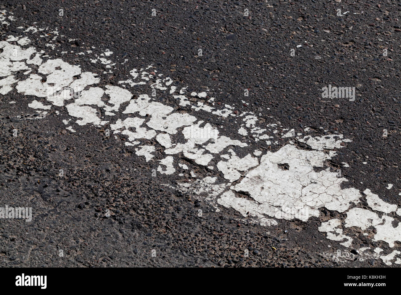Old worn white line of a pedestrian crossing across the roadway. Photo ...