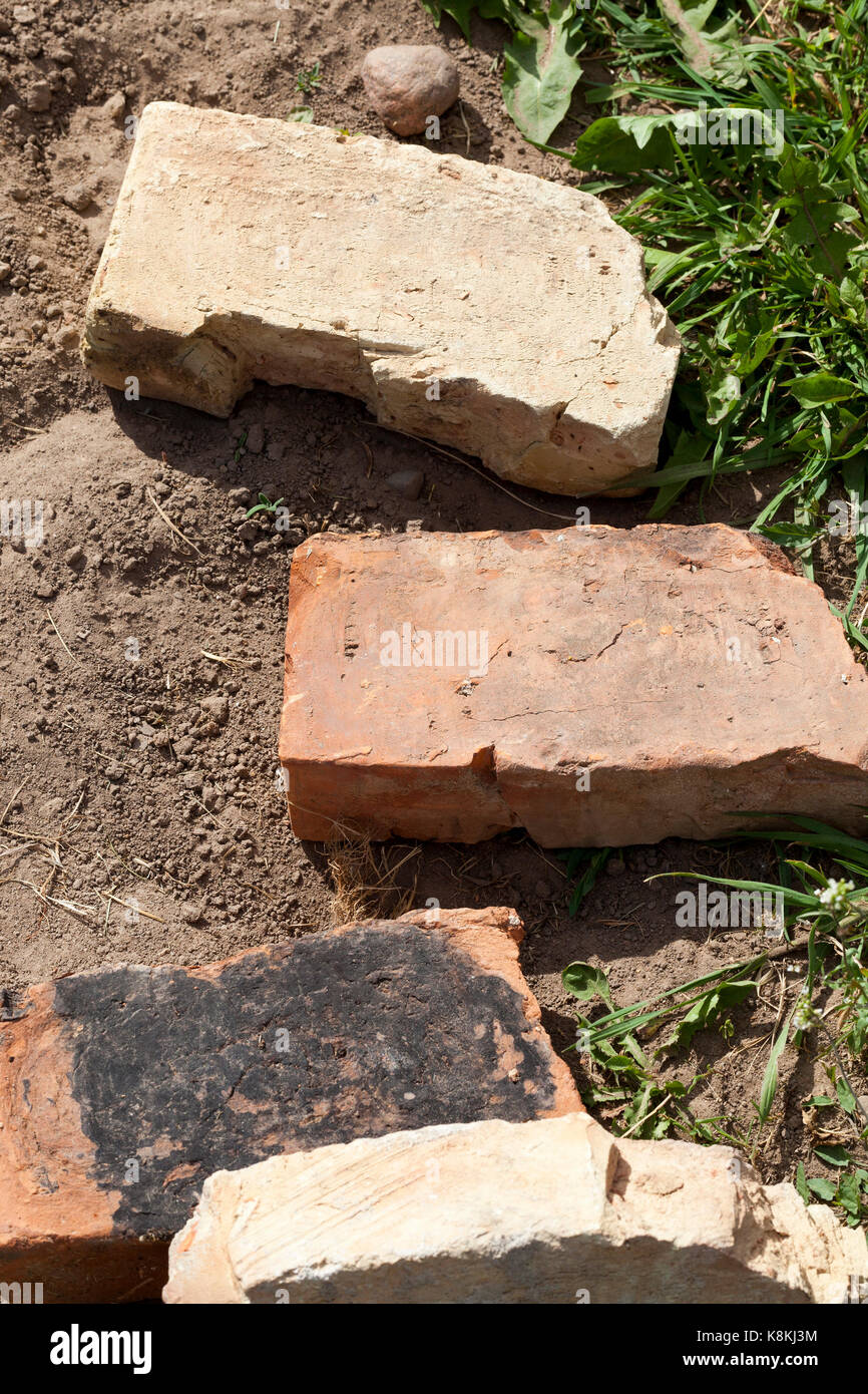 Old bricks lying on the ground. Building debris and materials from the ...