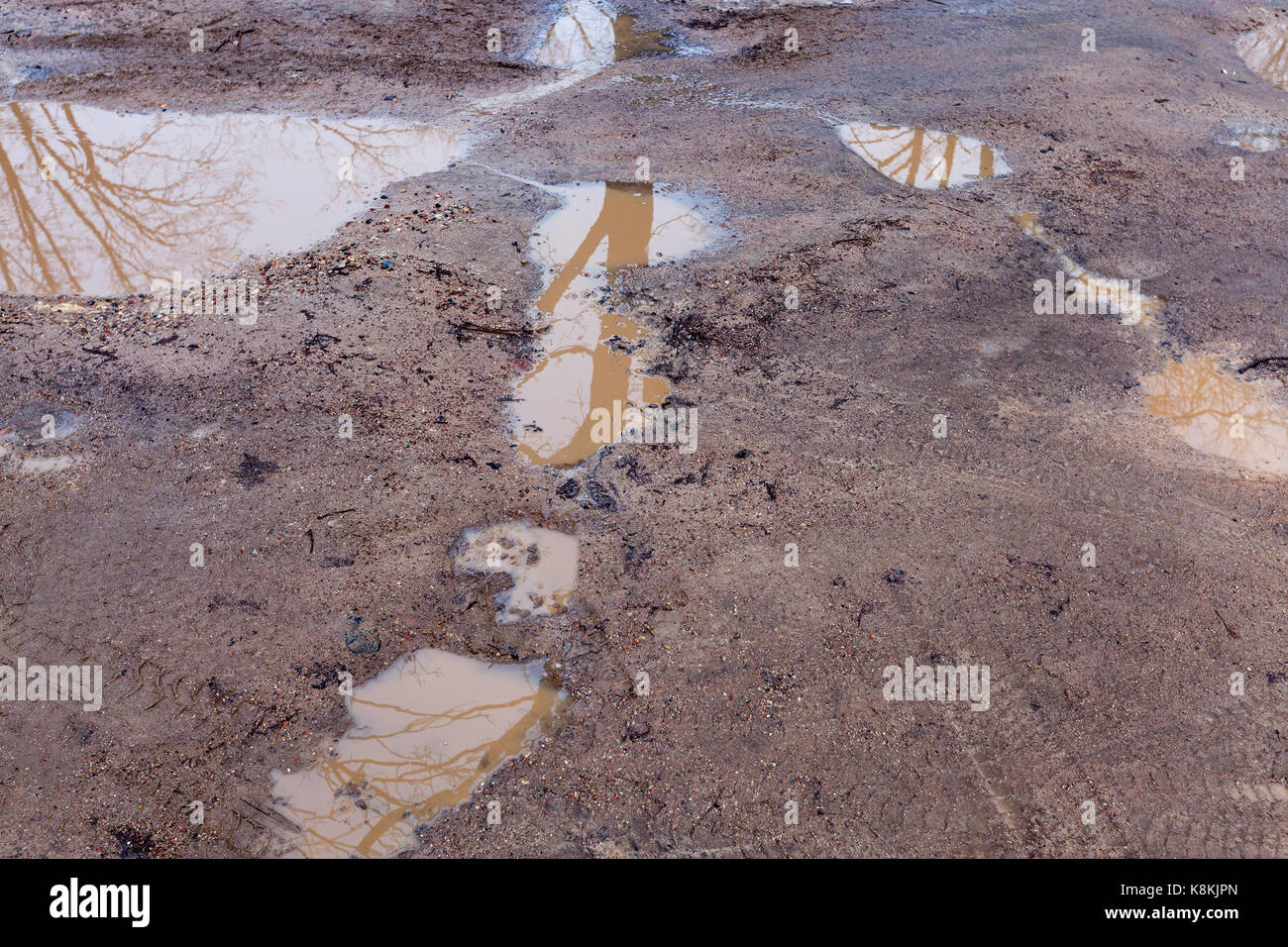 rural road of poor quality - off-road. Surface with pits filled with ...