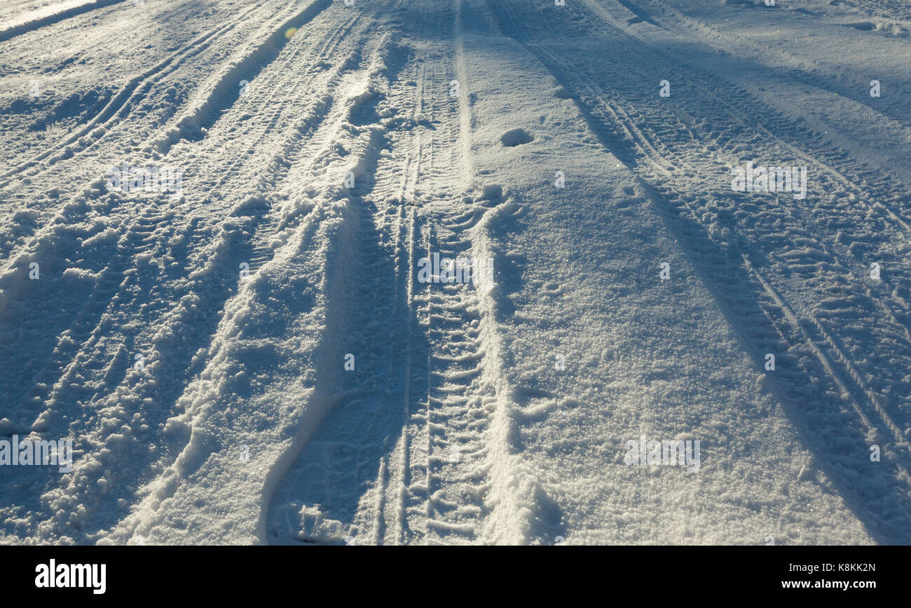 rough curve road in the winter season, covered with snow and ice. On ...