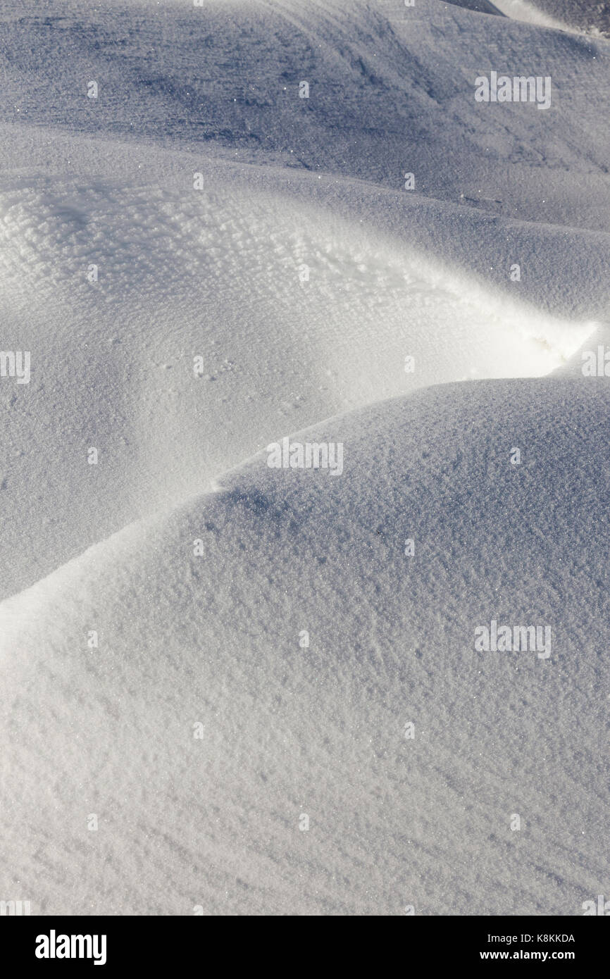 high snowdrifts of white pure snow in the winter season after snowfall ...