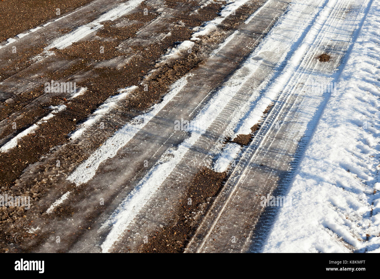 part of the asphalt road and the roadside in the winter season. on the ...