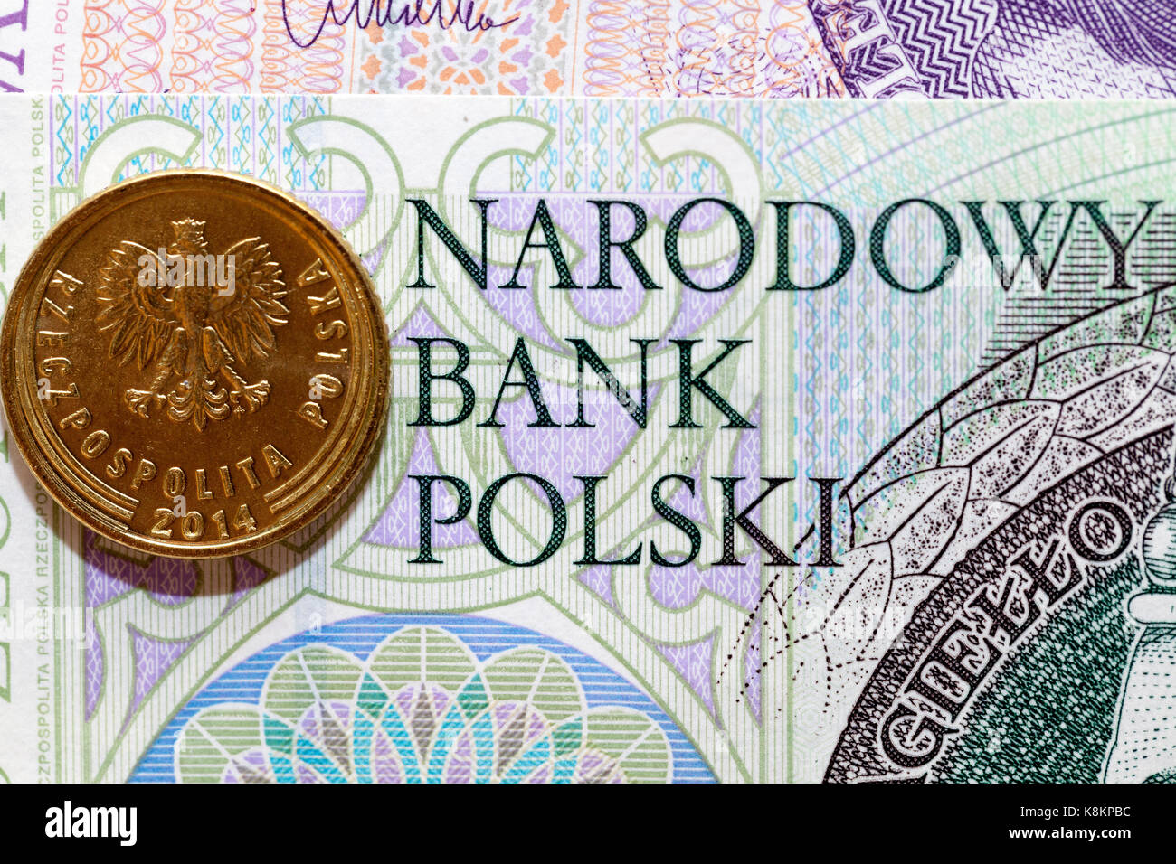 one Polish coin, lying on the paper currency of Poland. Photographed ...