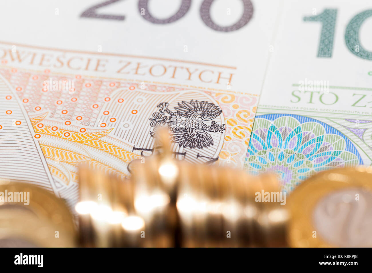 Polish banknotes and coins photographed close-up. Shown details of ...