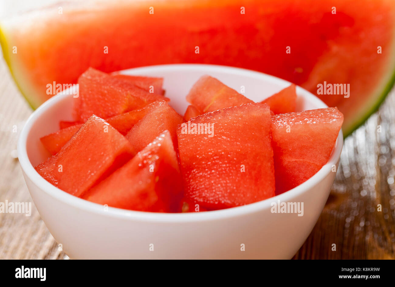 Red juicy and sweet watermelon cut into pieces and folded to a white ...