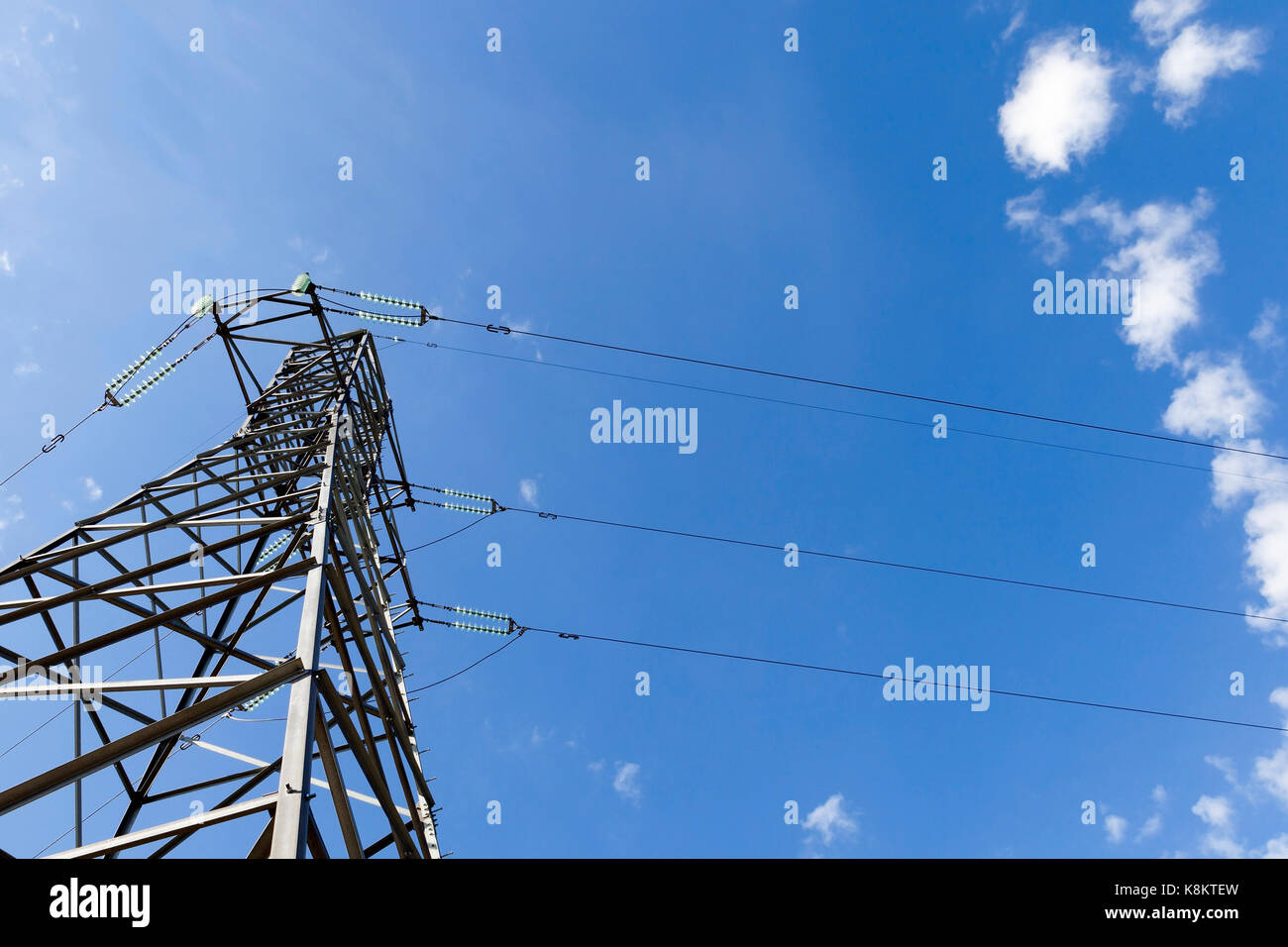 High-voltage power lines installed on high metal poles. photo close-up ...