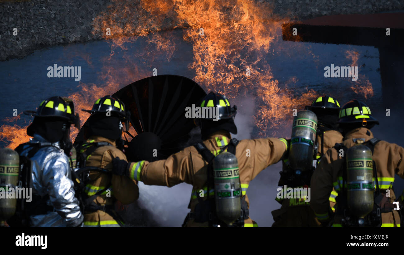 Firefighters from the 2nd Civil Engineer Squadron advance on the fire ...