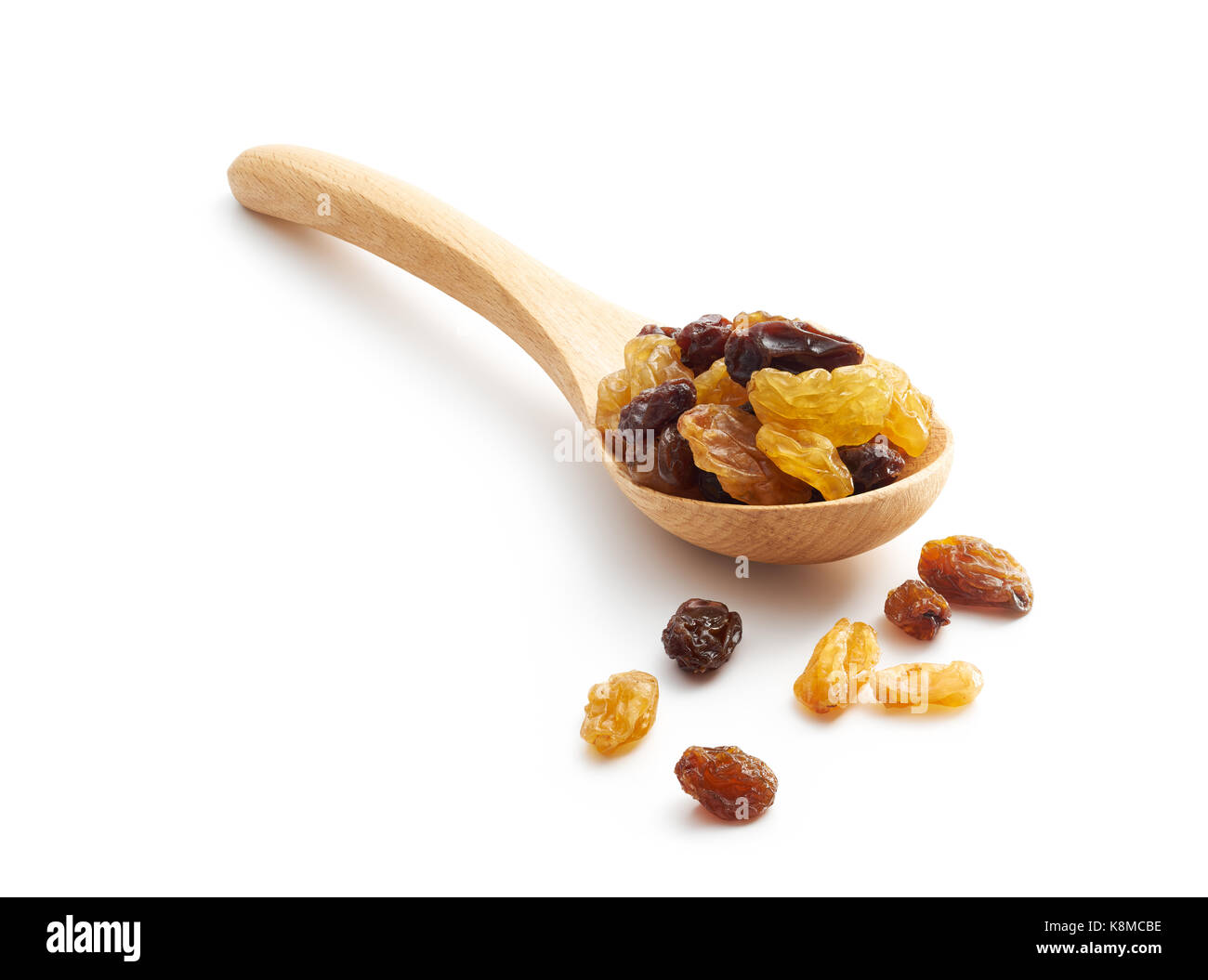Raisin on wooden spoon isolated over white background Stock Photo - Alamy