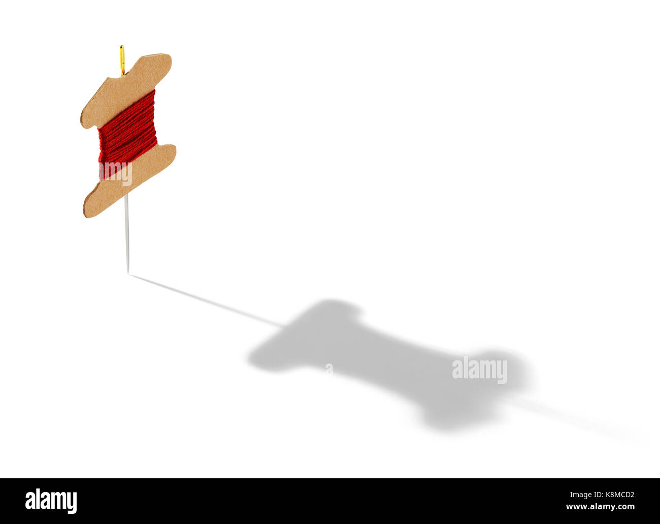 Needle, thread and kraft card bobbin Stock Photo - Alamy