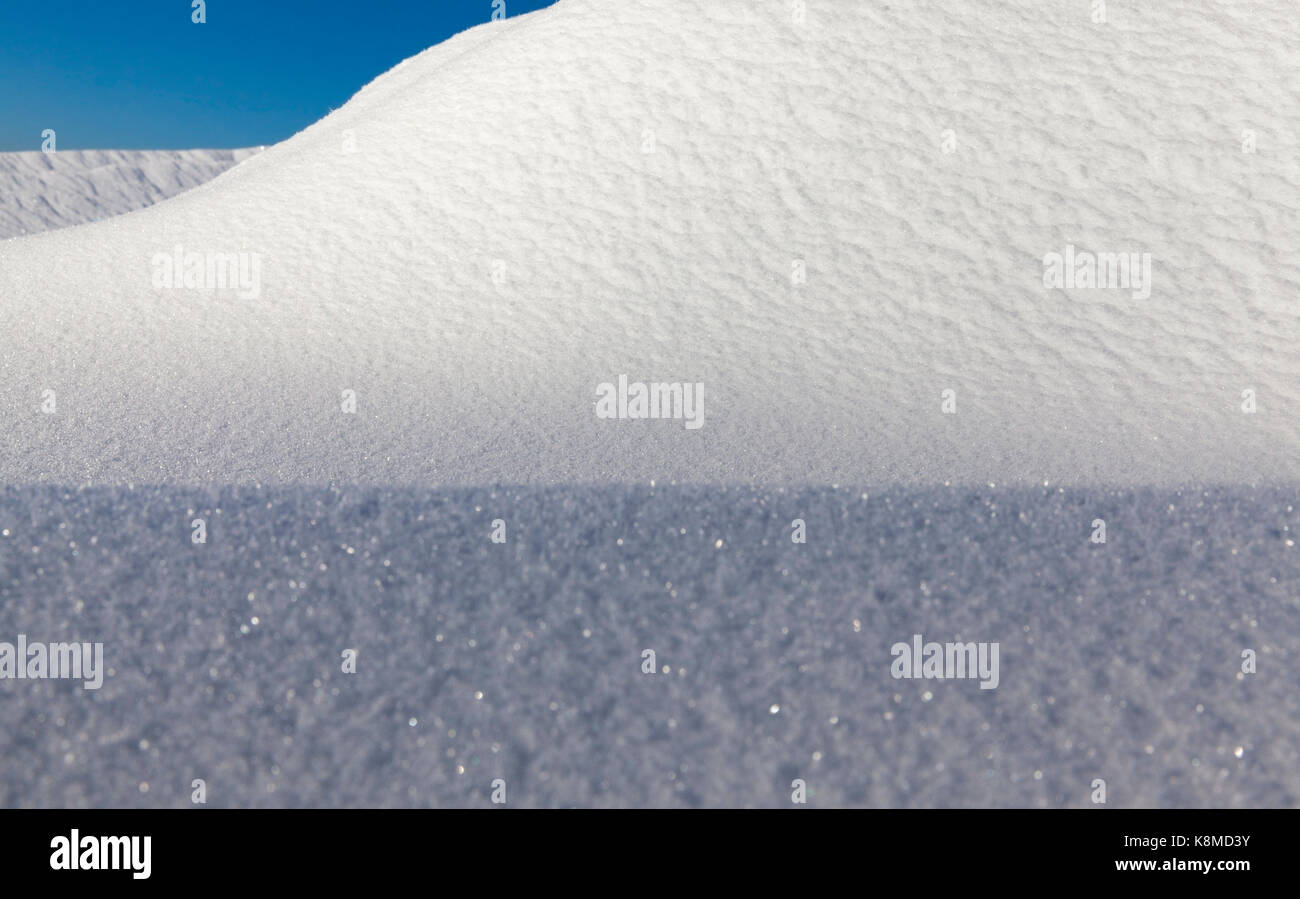 beautiful white snowdrift snow photographed close-up on the side. in ...