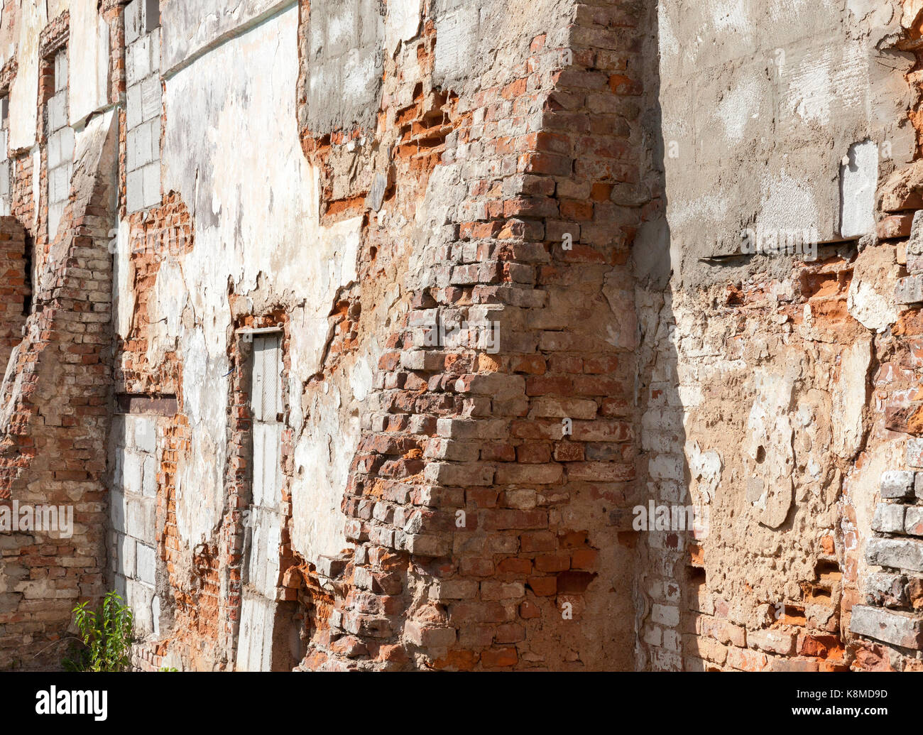 part of the wall of a severely collapsing building, reinforced by an ...