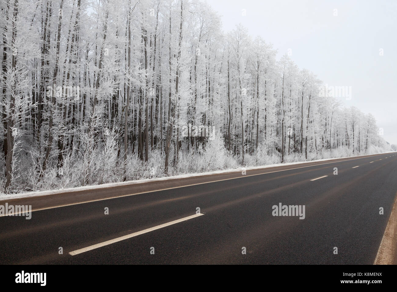 a snow-covered road in the winter season. Close-up photo Stock Photo ...