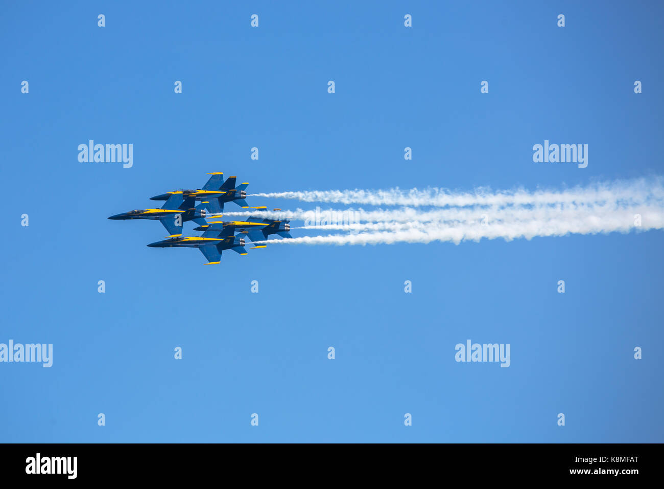 US Navy Blue Angels F/A-18 Hornets flying in formation against a blue ...