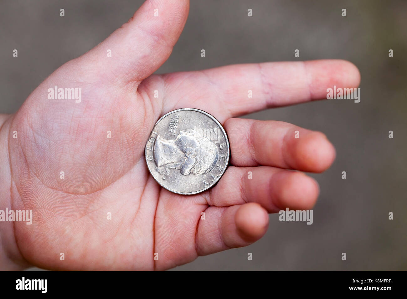 lying in the hand of the child's American coin in a quarter. Photo ...