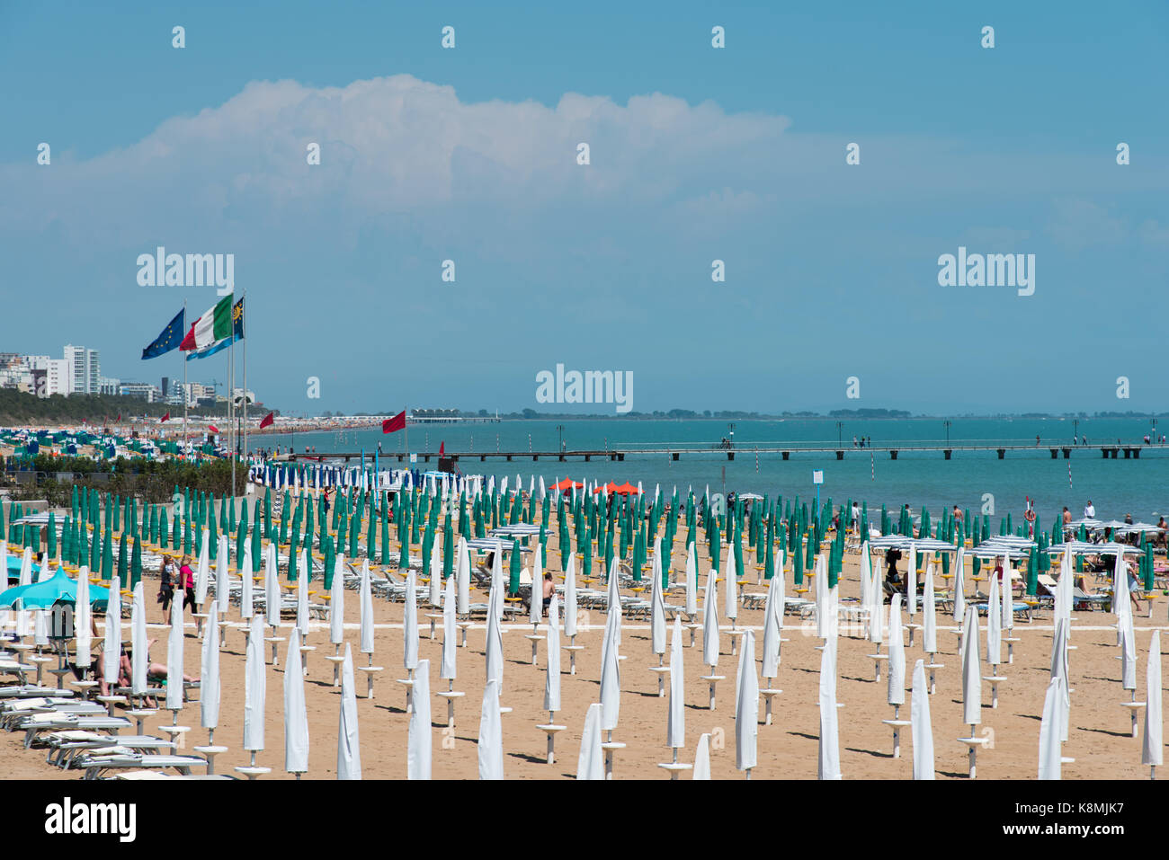 Lignano Sabbiadoro. Lighthouse, beach and umbrellas Stock Photo - Alamy