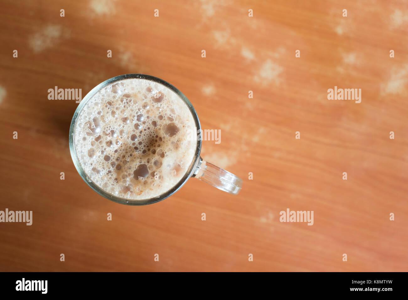a glass of tea with milk on a table at mamak restaurant.famous or ...