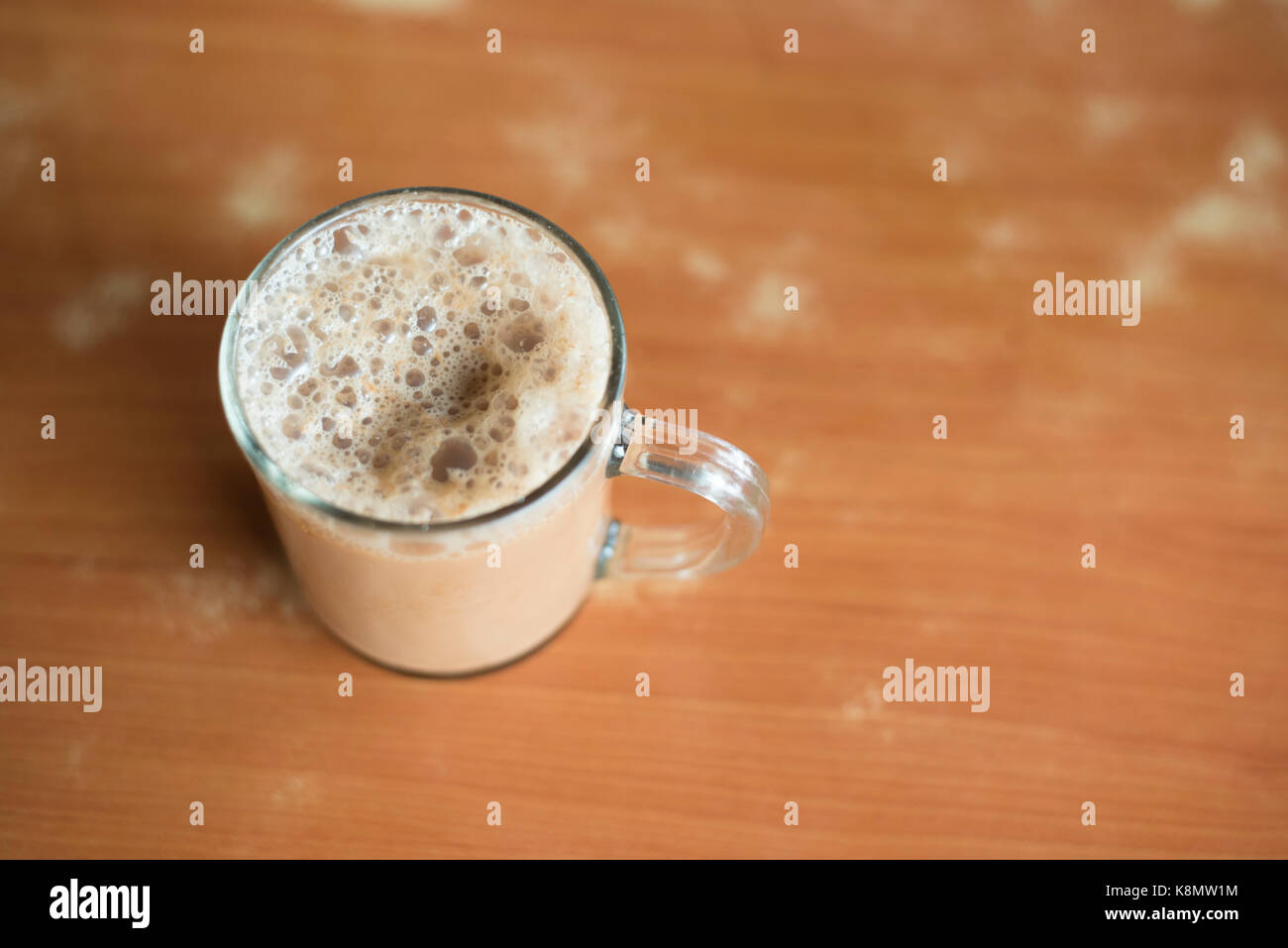 a glass of tea with milk on a table at mamak restaurant.famous or ...
