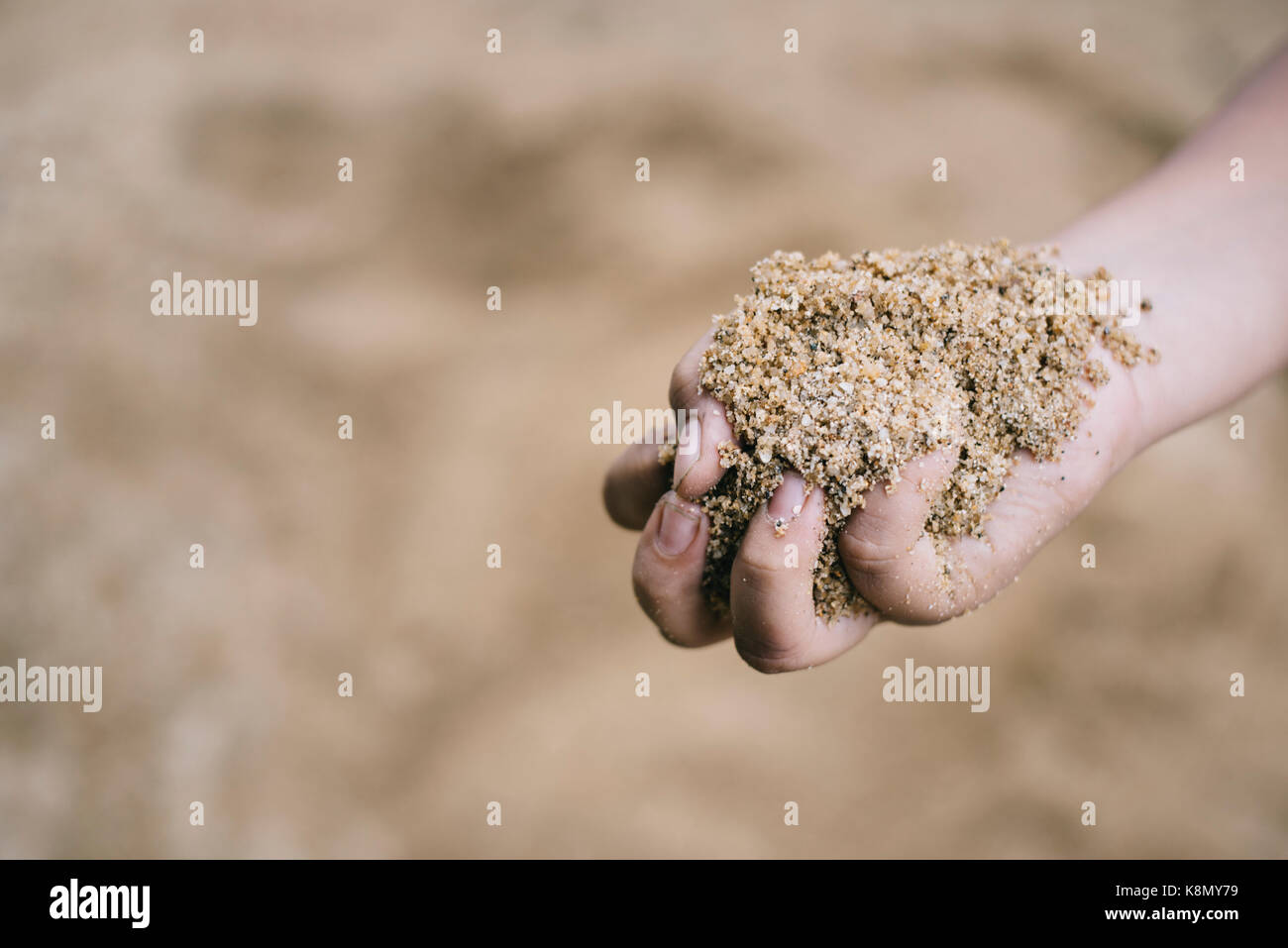 kid showing a sand with hand (selective focus).kids growth developmant ...