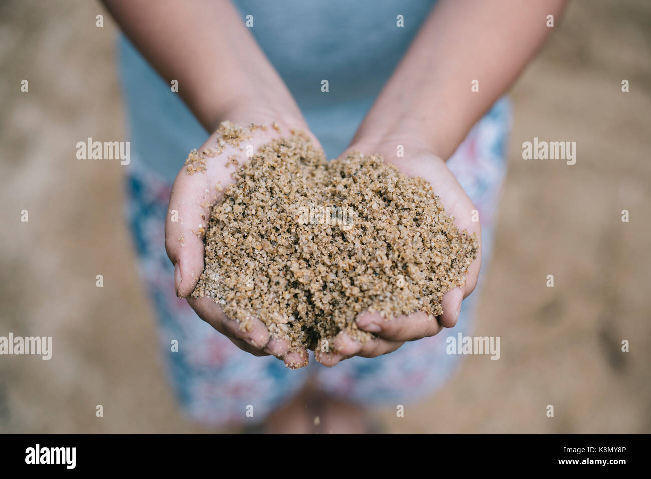 kid showing a sand with hand (selective focus).kids growth developmant ...