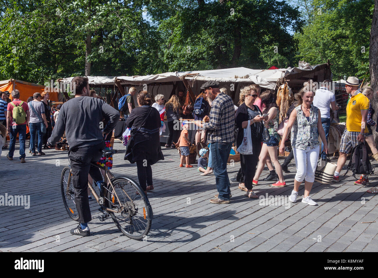 TURKU, FINLAND ON JUNE 30, 2017. Street view, people walk around stands ...