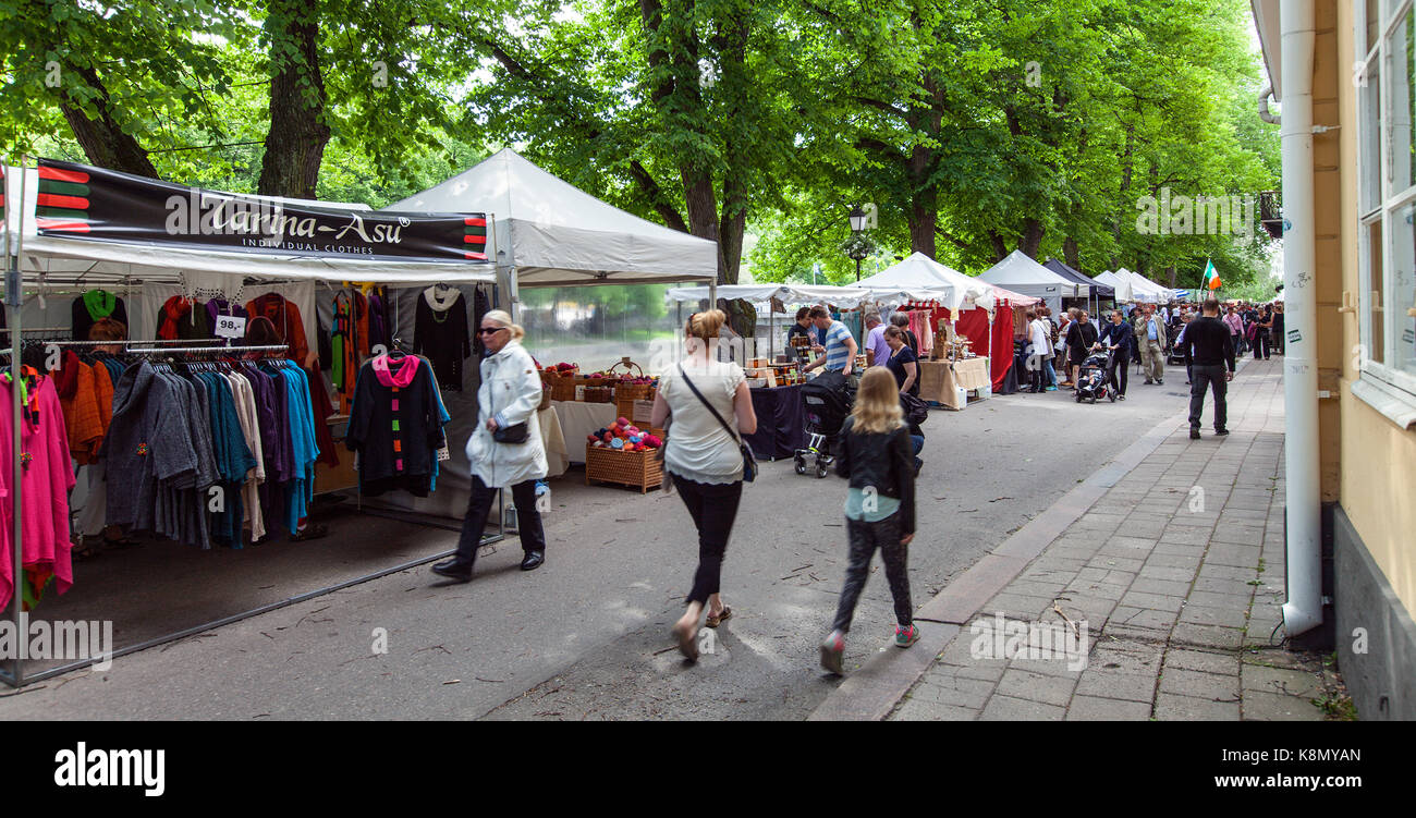 TURKU, FINLAND ON JUNE 30, 2017. Street view, people walk around stands ...