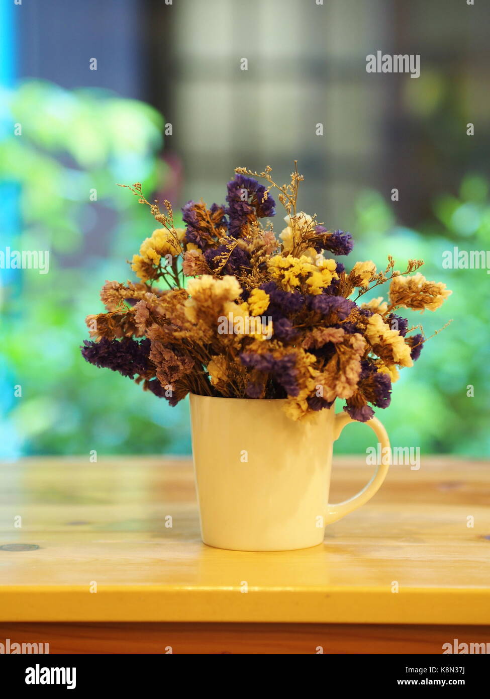 Dry Flower with a cup , vast , pot. on the wooden table, minimal style ...
