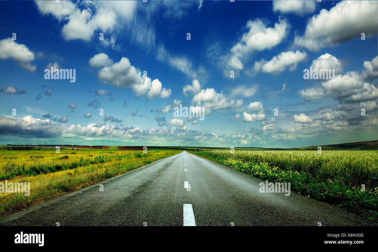 image of wide open prairie with a paved highway stretching out as far ...