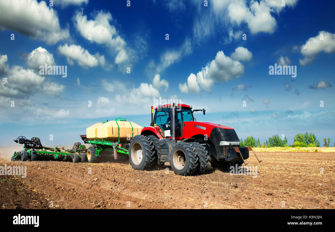 tractor in a field plowing Stock Photo - Alamy