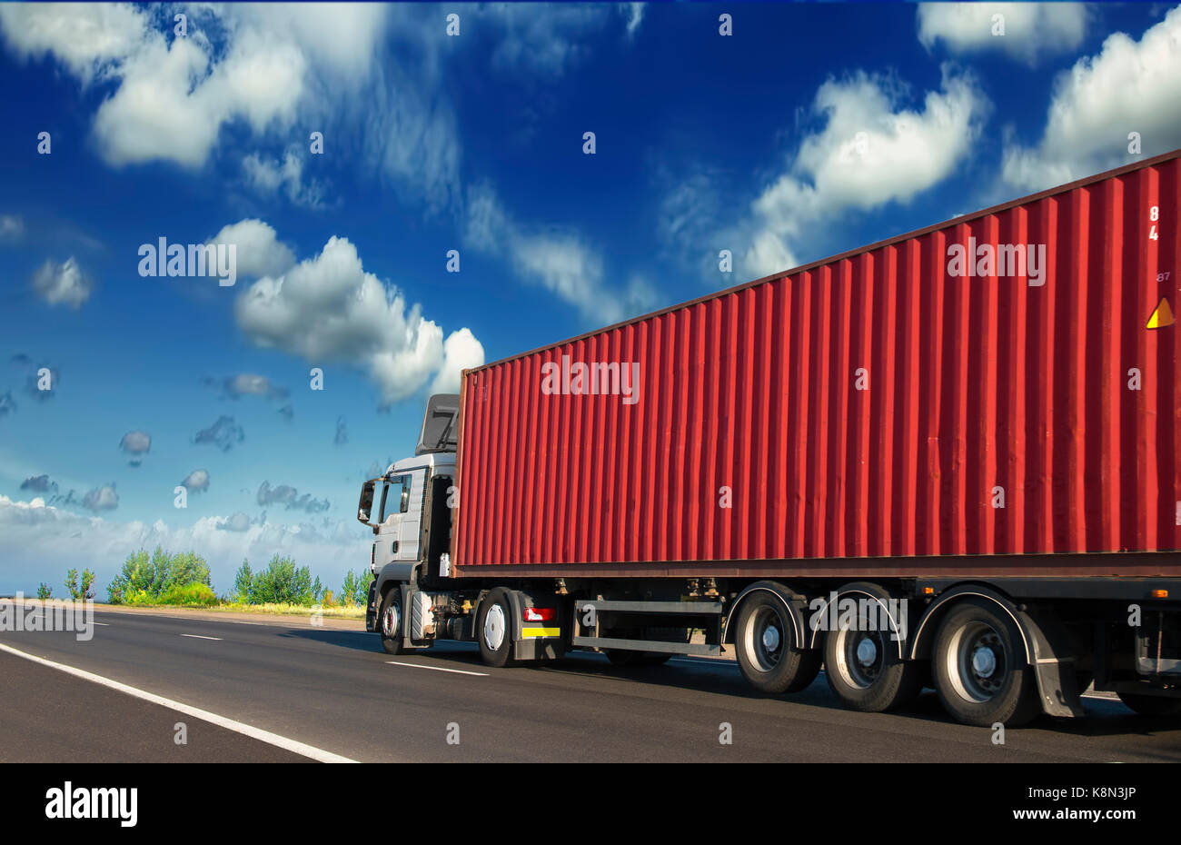 Trailers carrying containers clear day on the highway Stock Photo - Alamy