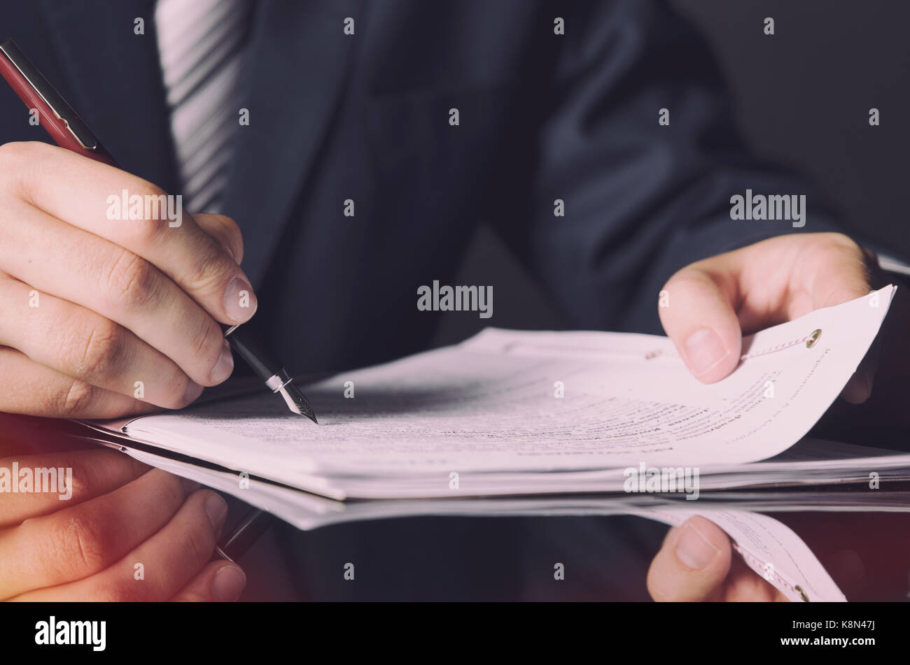 Notary signing a contract with fountain pen in dark room concept. pen ...