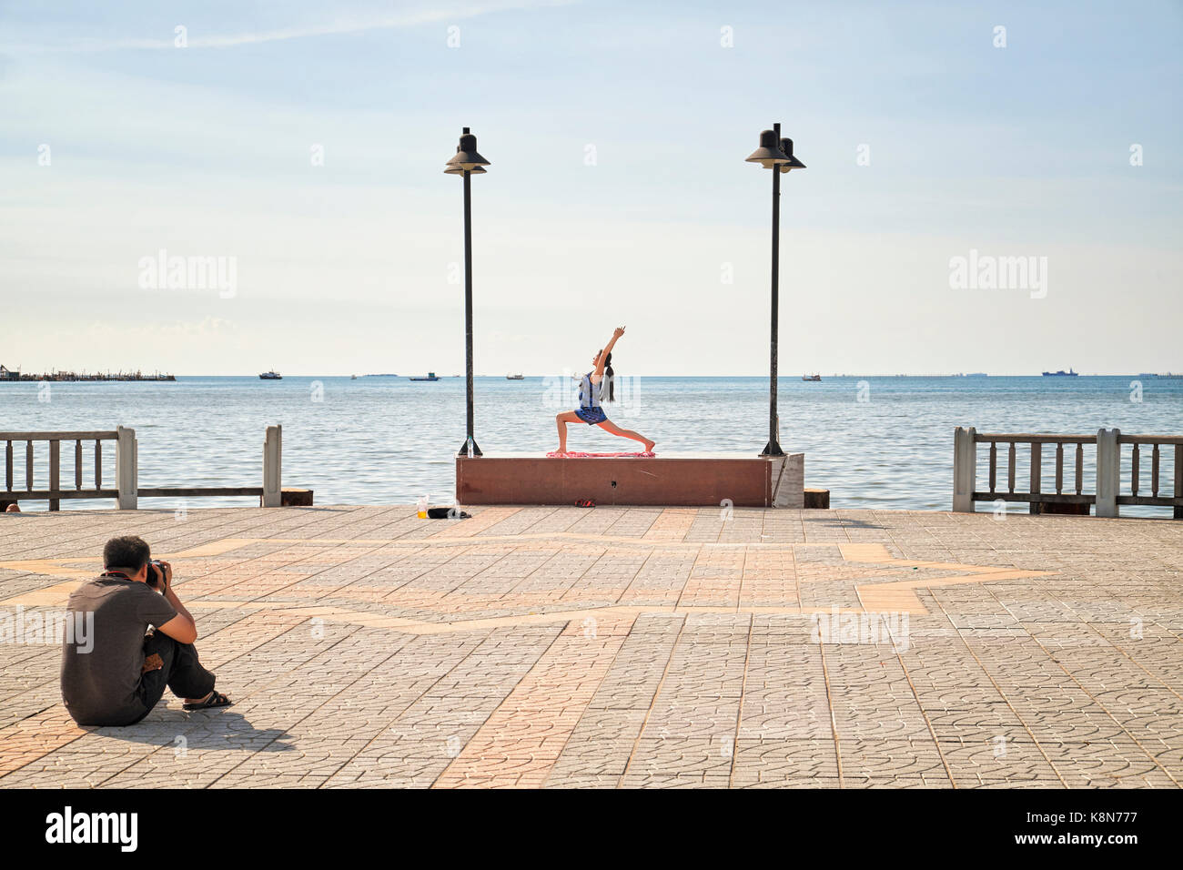 Photographer with model working outdoors. Photographer shooting outside ...